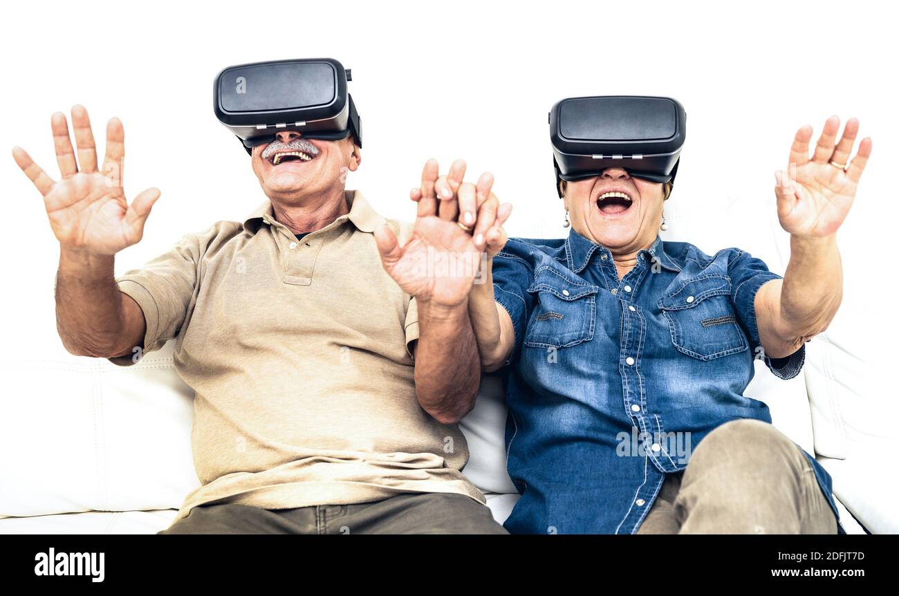 Senior mature couple having fun together with virtual reality headset ...
