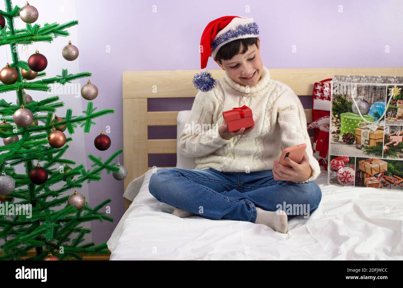 Online congratulations. Christmas online greetings. Happy boy shows ...