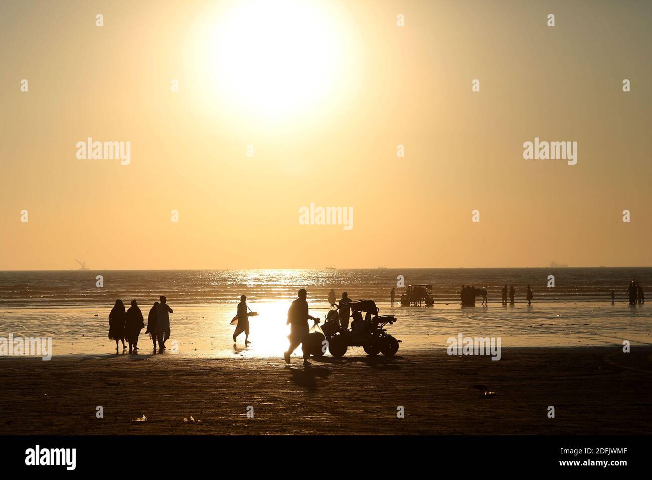 Karachi. 4th Dec, 2020. Tourists enjoy the view of sunset at a beach in ...