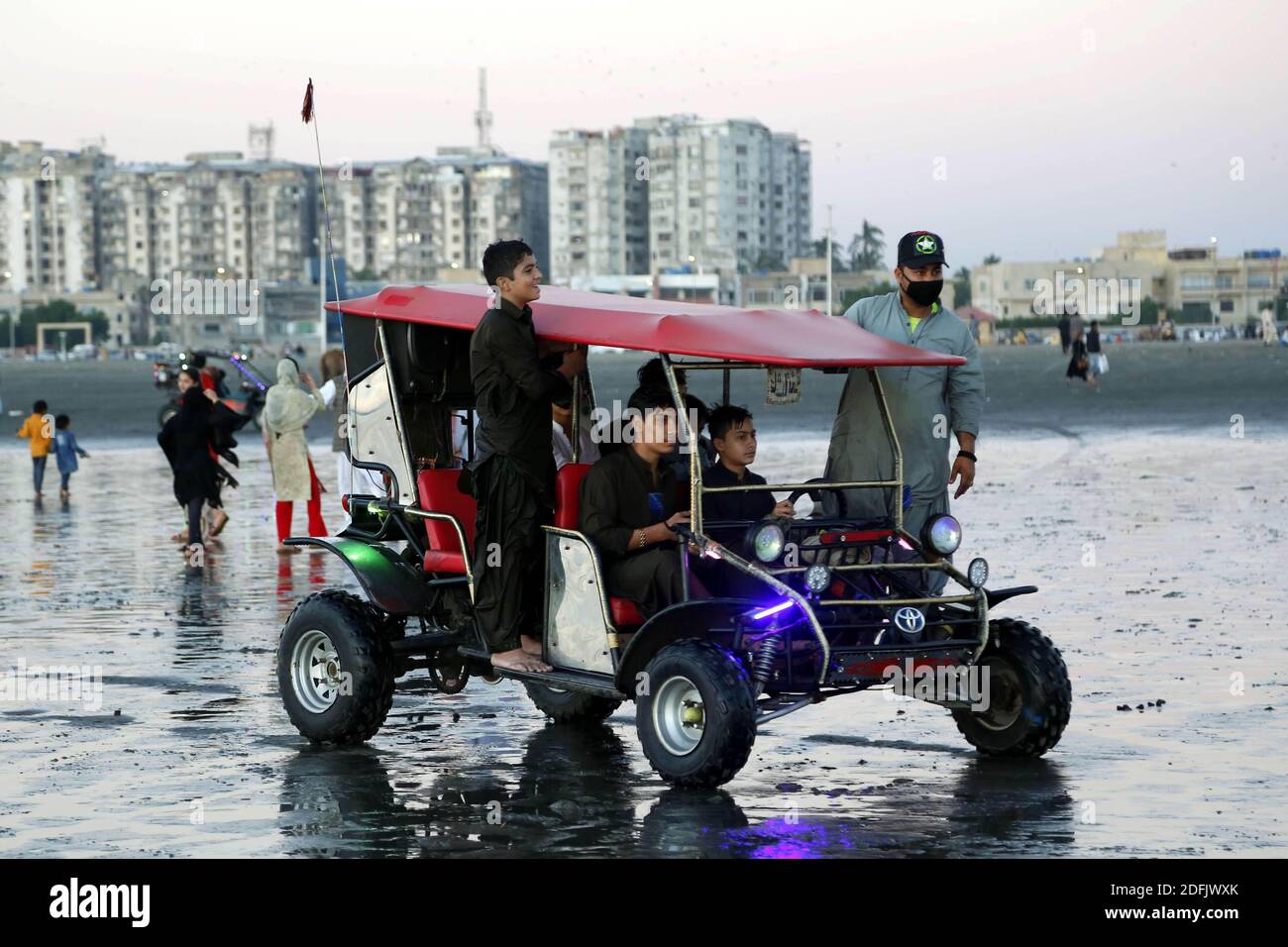Karachi. 4th Dec, 2020. Tourists enjoy riding on an electric vehicle at ...