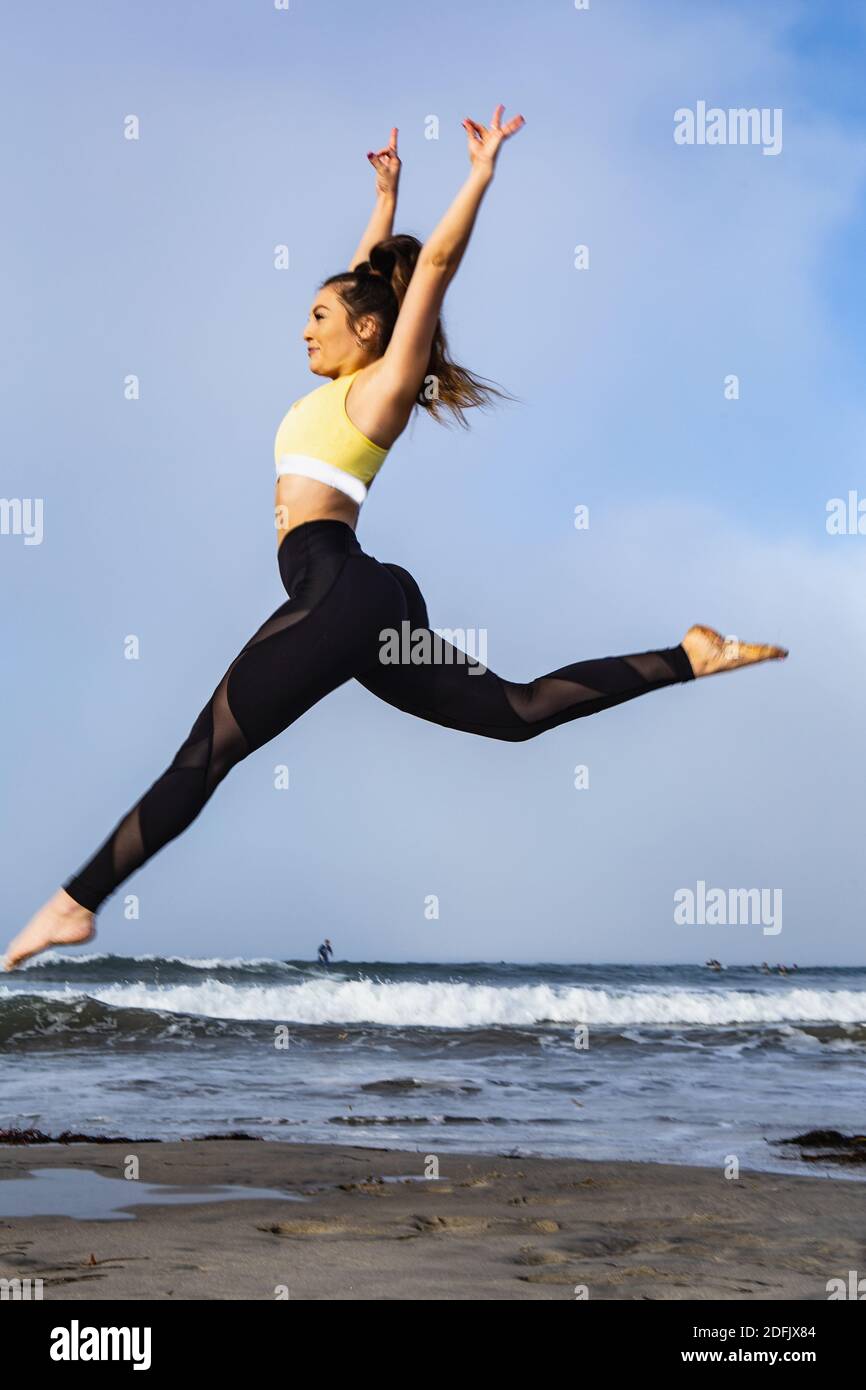 Woman leaping beach hi-res stock photography and images - Alamy