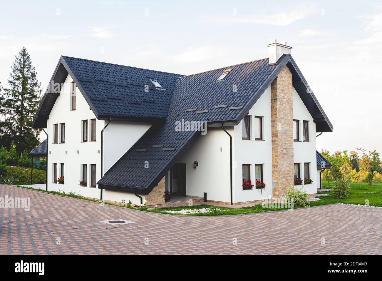 A modern white house with a blue roof shingles Stock Photo - Alamy