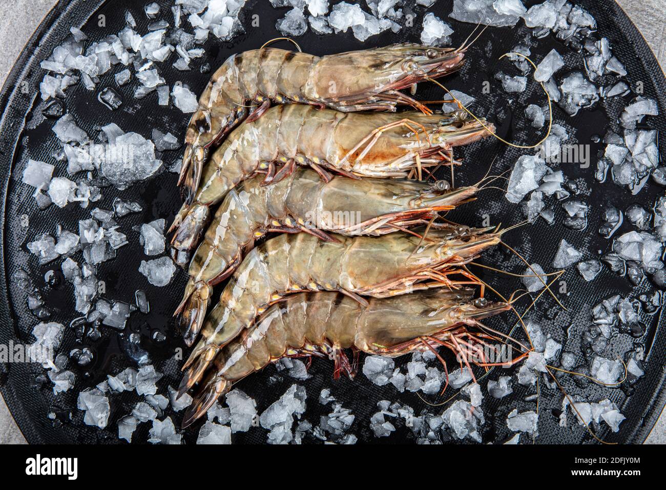 Raw whole fresh uncooked prawns shrimps on marble plate, stone ...