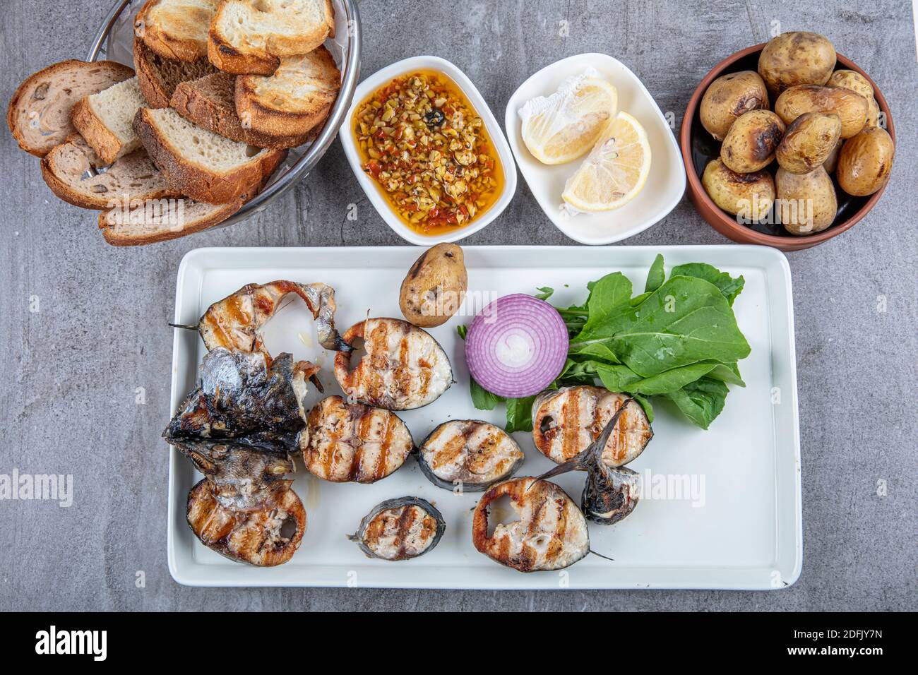 Bonito slices lined on a plate. Delicious traditional Turkish fish dish ...