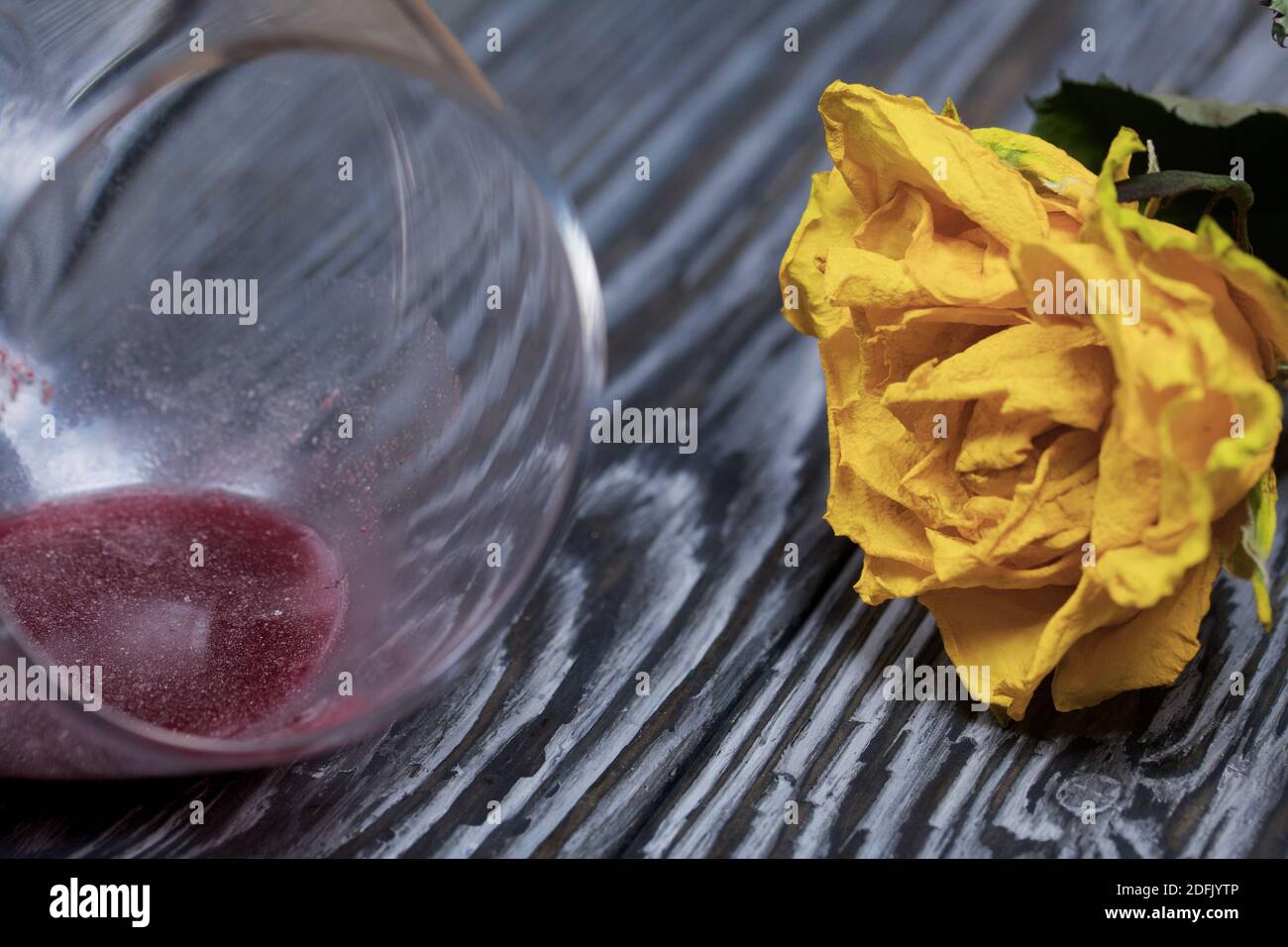 A bouquet of dried yellow roses. An overturned glass of sour wine. On ...