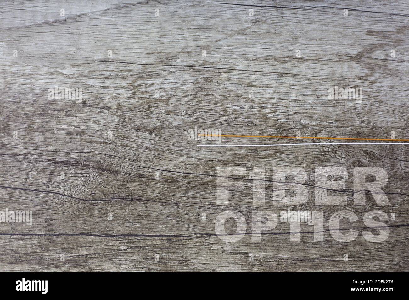 A top view shot of wood texture with an inscription "Fiber optics" on ...