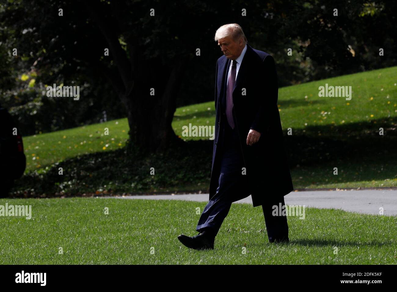 U.S. President Donald Trump walks on the South Lawn of the White House ...