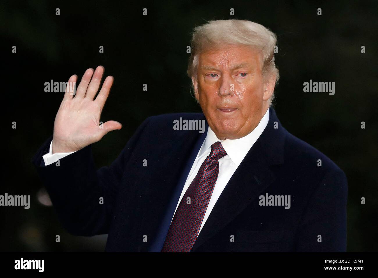 U.S. President Donald Trump waves as he walks on the South Lawn of the ...