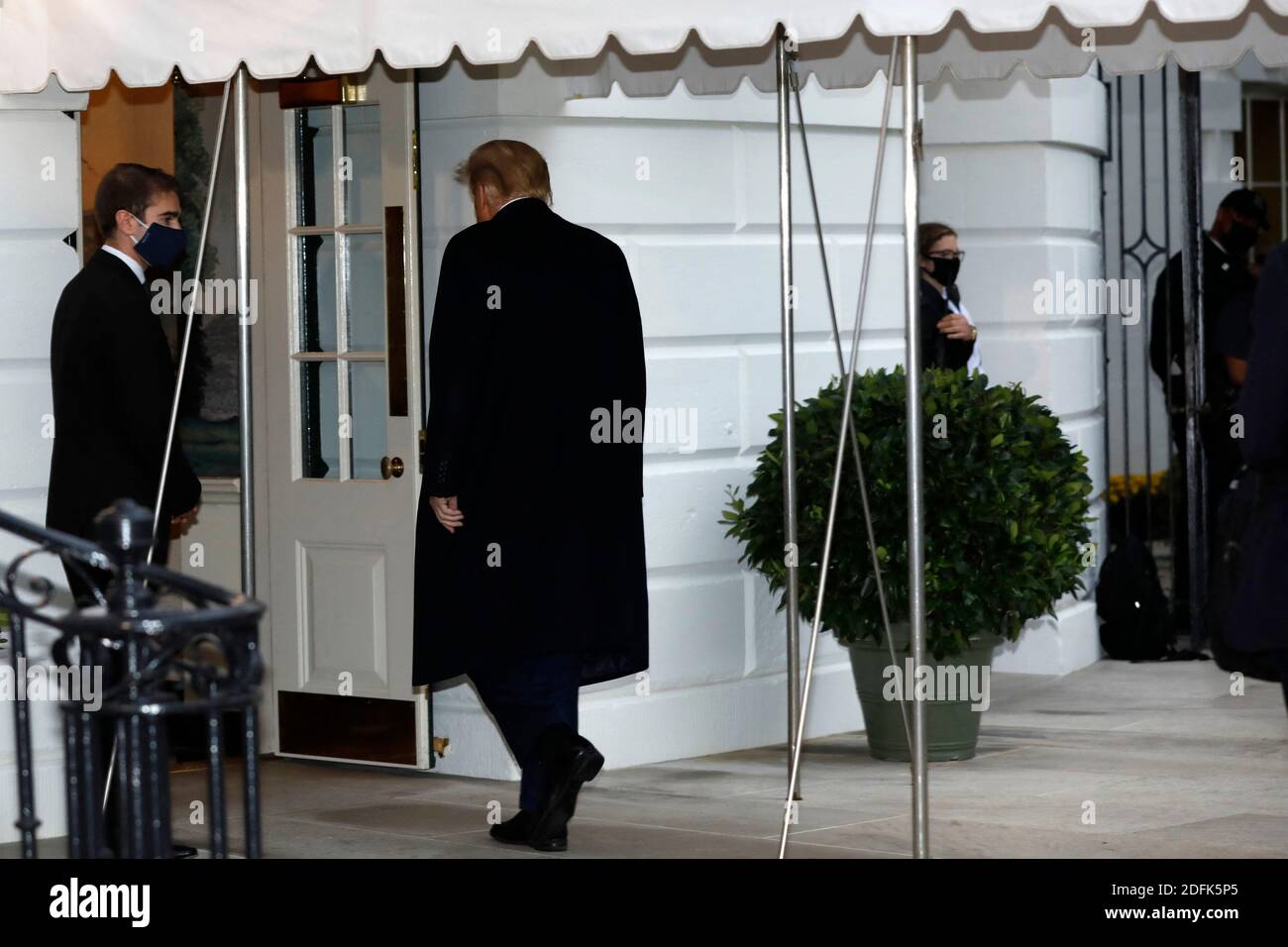 U.S. President Donald Trump enters the White House upon his return to ...