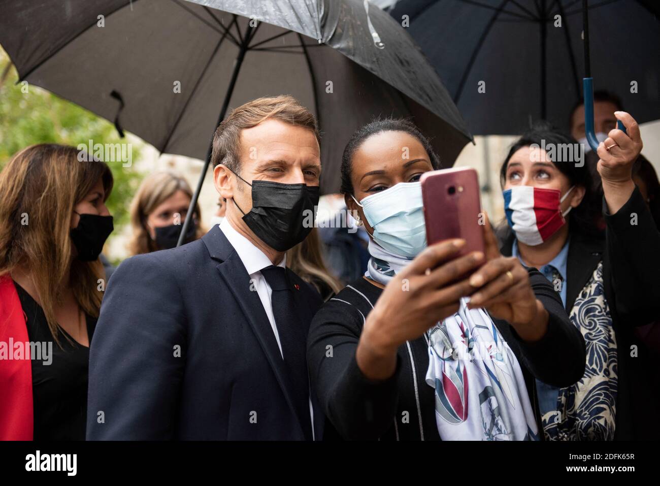 French President Emmanuel Macron during a visit in in Les Mureaux ...