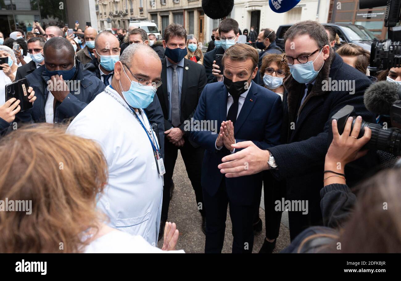French President Emmanuel Macron talks with caregivers and doctors in ...