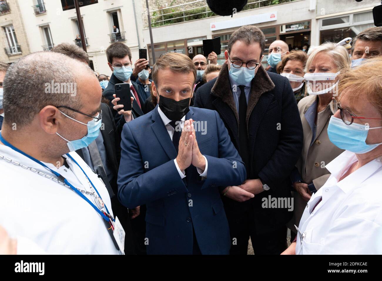 French President Emmanuel Macron talks with caregivers and doctors in ...