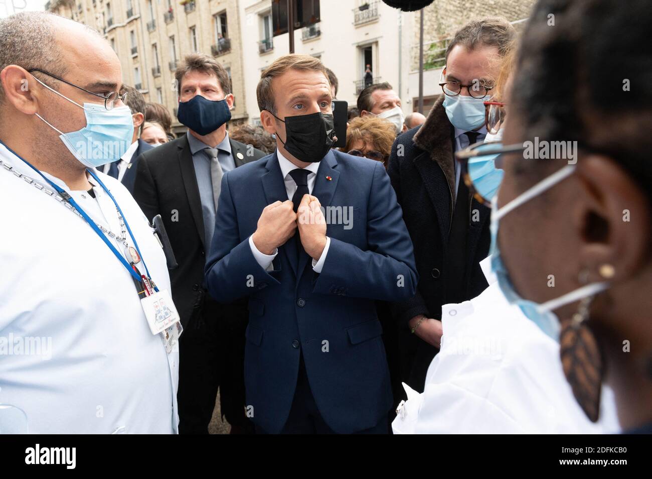 French President Emmanuel Macron talks with caregivers and doctors in ...