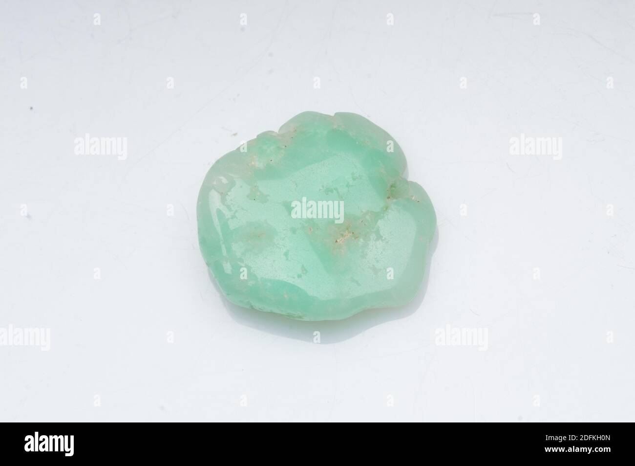 Natural chrysoprase stone on white background Stock Photo - Alamy