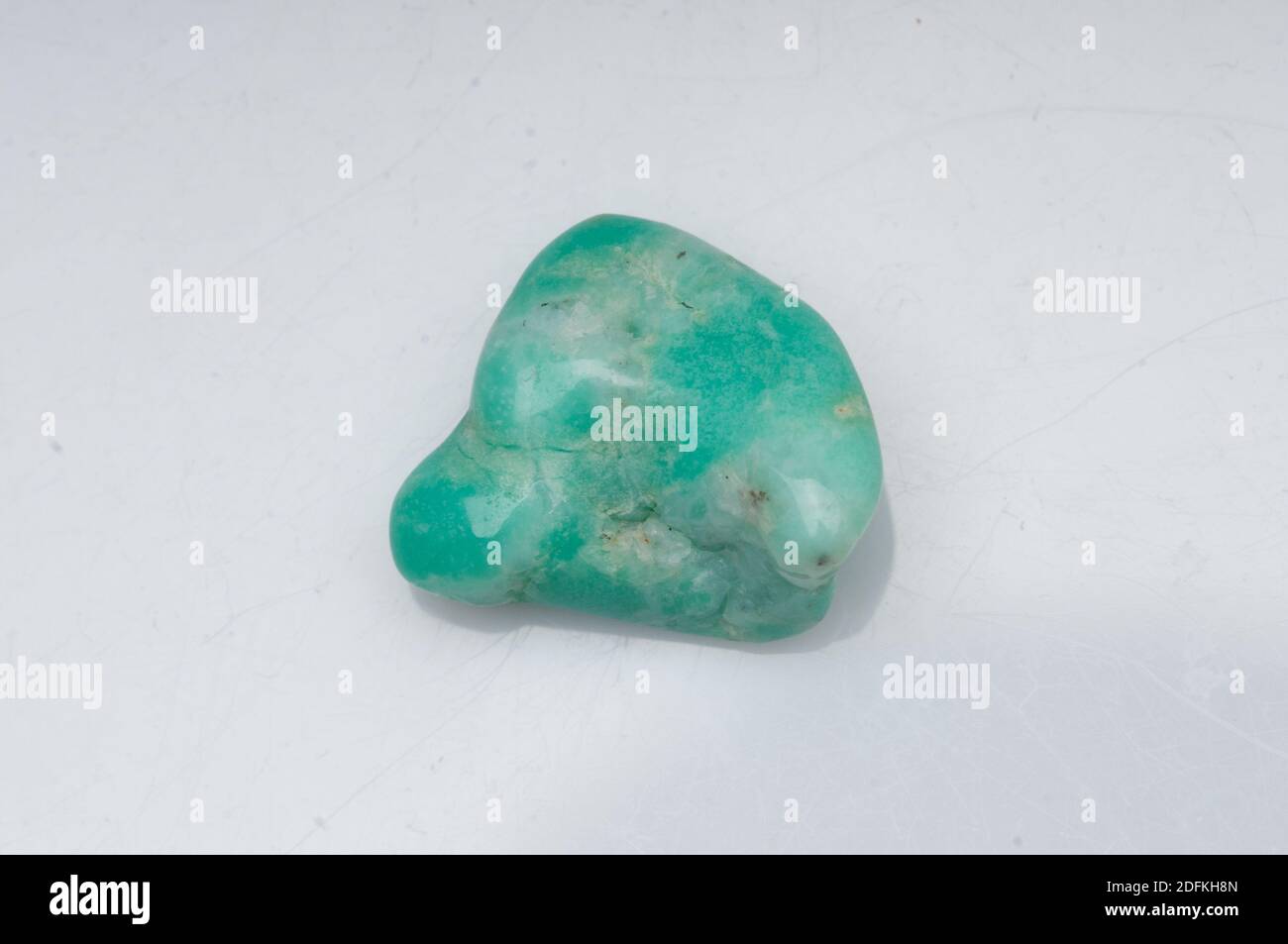 Natural chrysoprase stone on white background Stock Photo - Alamy