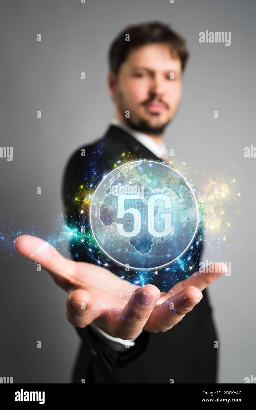 businessman presenting a virtual world map with message 5G in front of ...