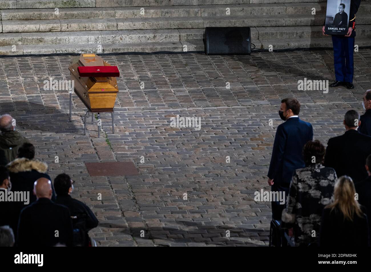 French President Emmanuel Macron stands in front of Samuel Paty's ...