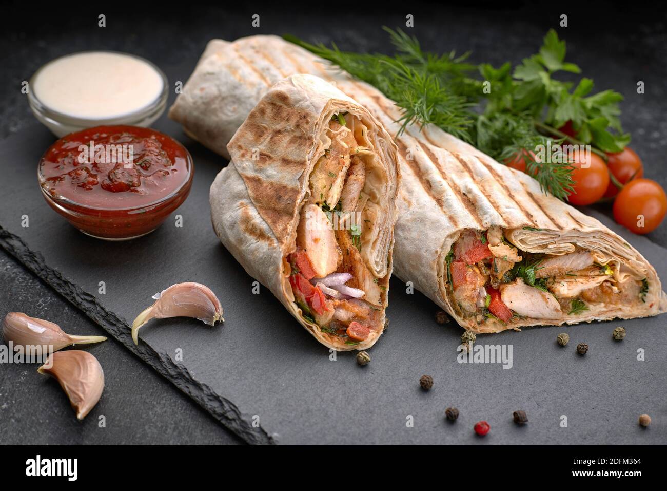 Shawarma with meat, cutaway, with sauce, tomatoes, cheese, herbs and ...