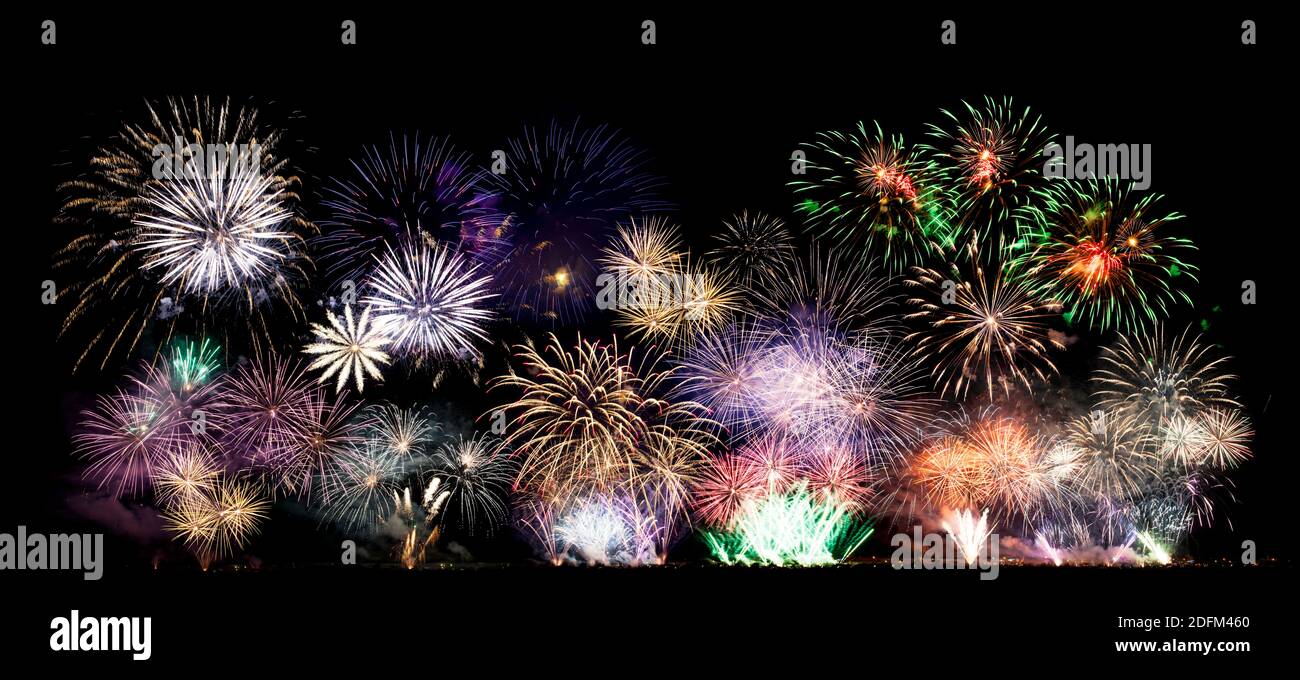 Colorful fireworks of various colors over night sky Stock Photo - Alamy
