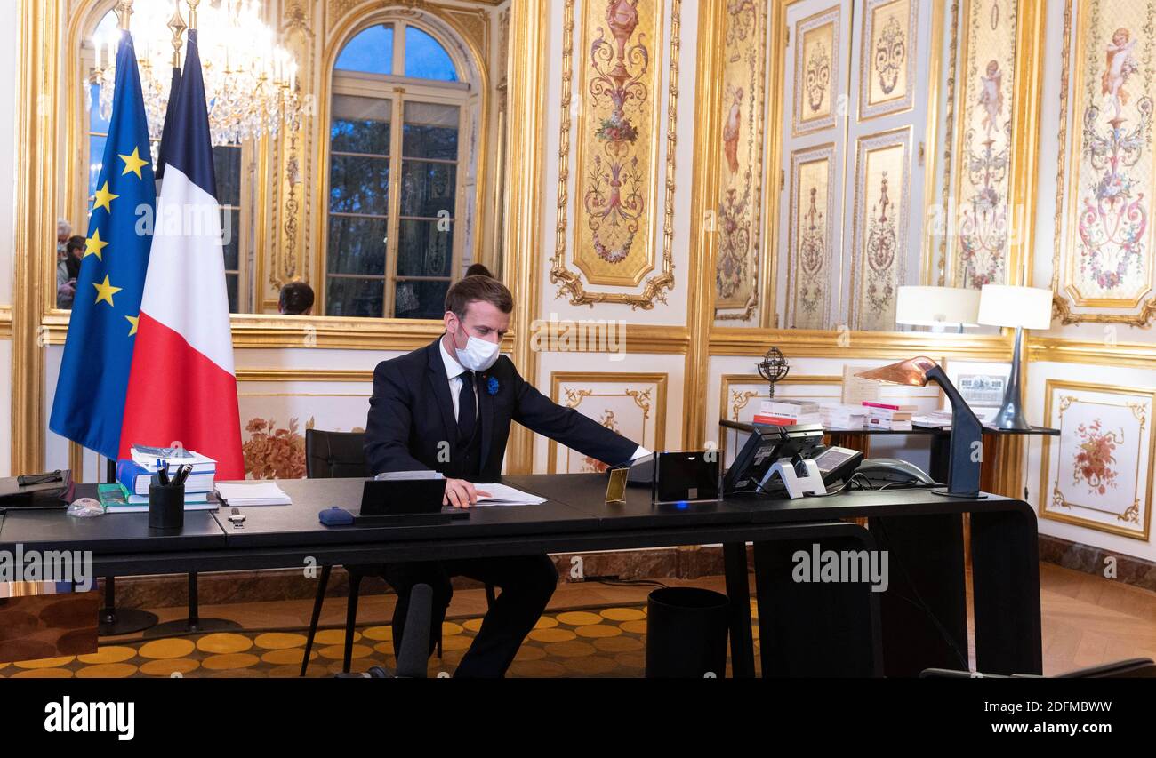 French President Emmanuel Macron in his office talks on the phone for ...