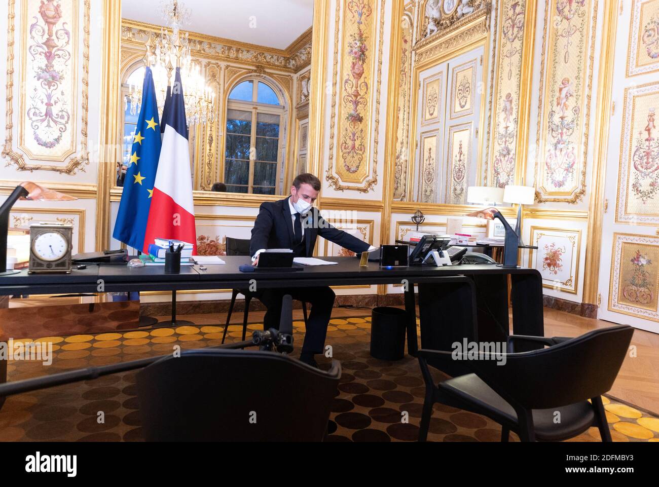 French President Emmanuel Macron in his office talks on the phone for ...