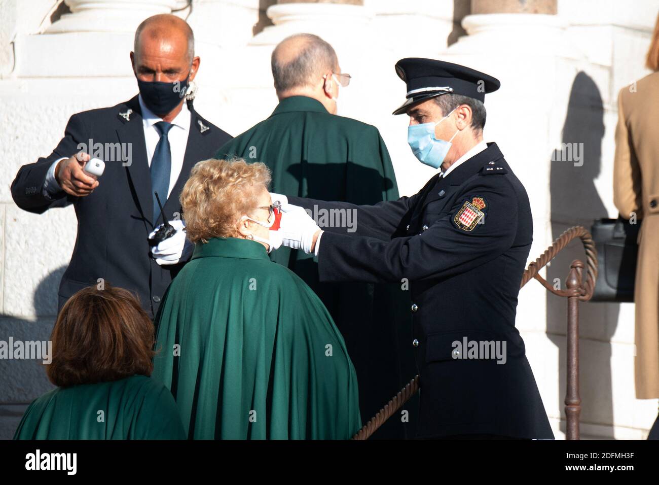A man checks the temperature of people at Cathedral of Monaco during ...