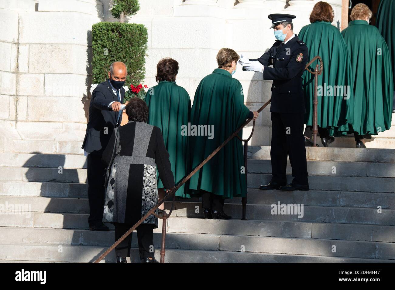 A man checks the temperature of people at Cathedral of Monaco during ...