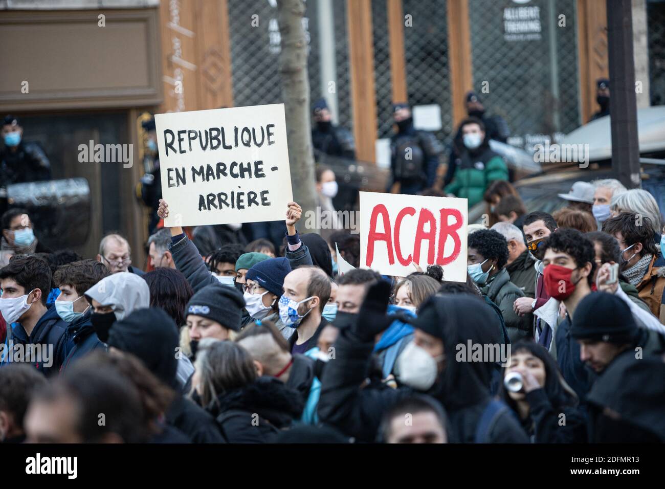 Protesters hold signs saying "republic in reverse " and "ACAB" during a ...