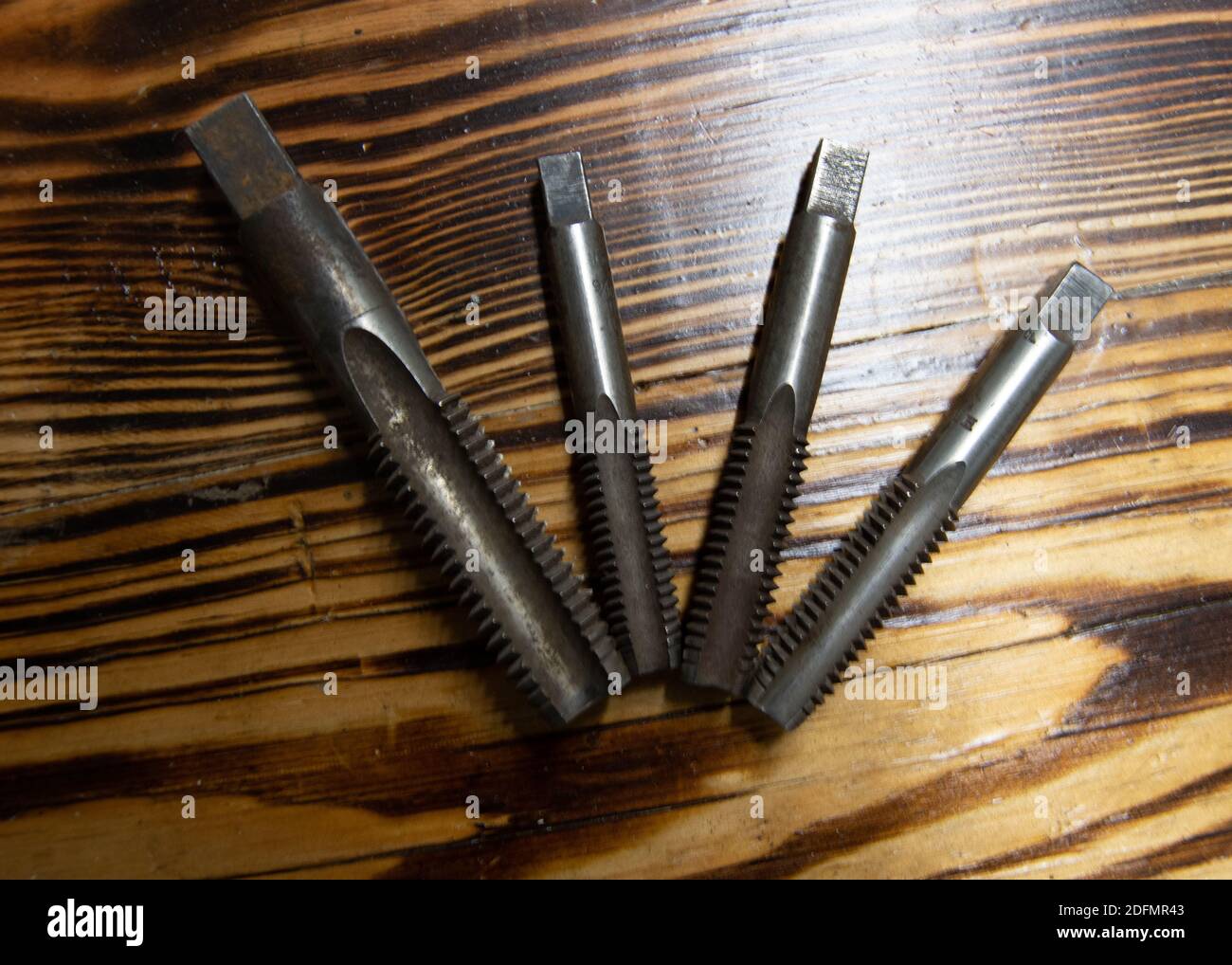 a flat lay of four hand taps on a wooden texture background Stock Photo ...