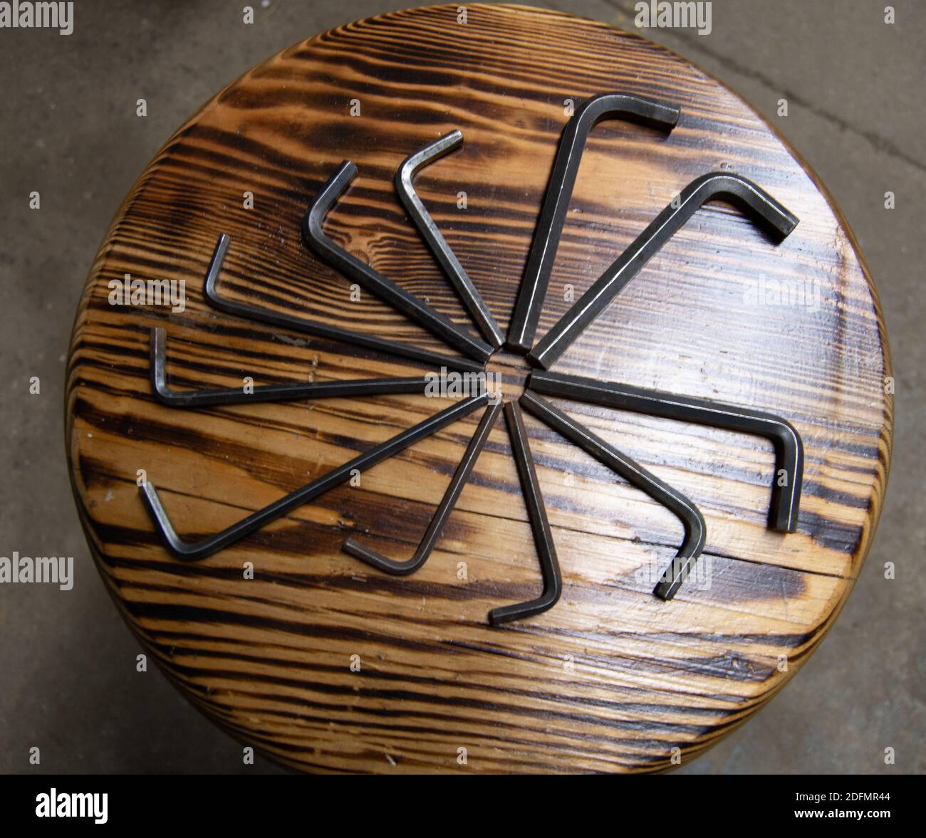 the multiple imbus hex keys forming a circle on a wooden texture ...