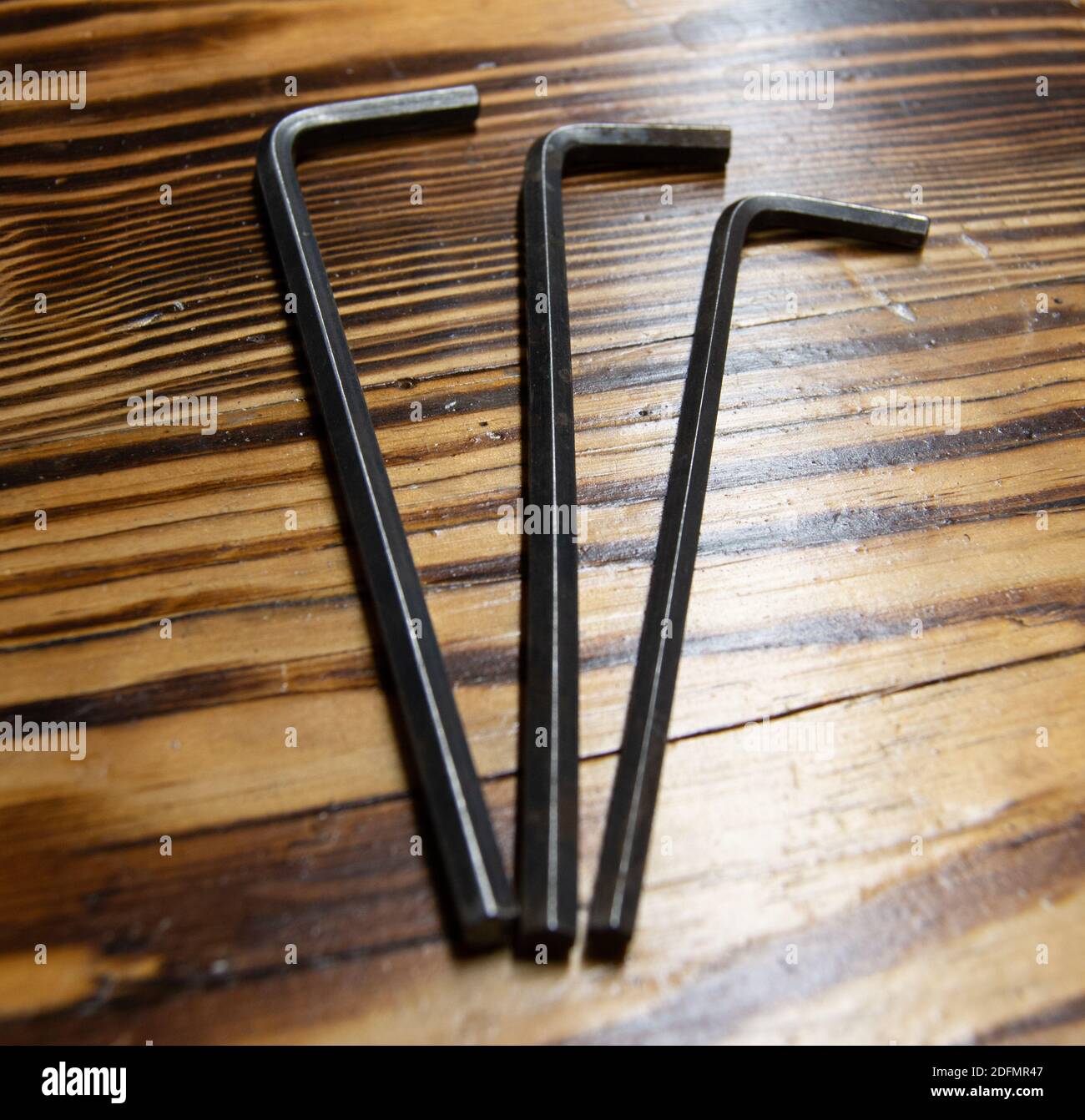 the three imbus hex keys on a wooden background Stock Photo - Alamy