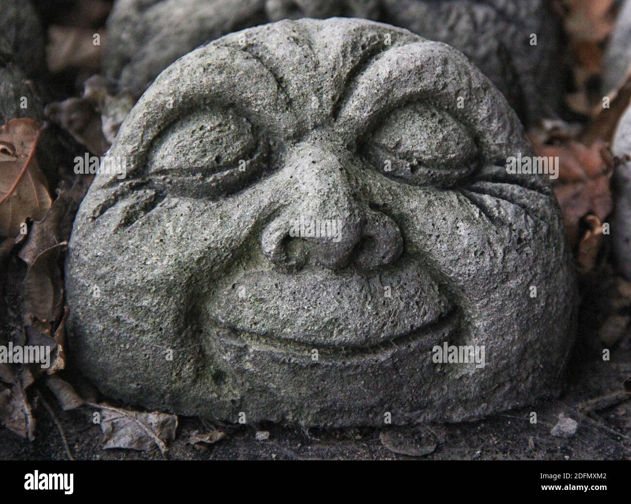 Close up of stone face with happy expression eyes closed Stock Photo ...
