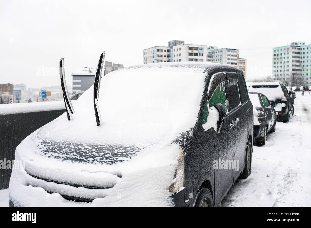 Car wipers covered with ice and snow after cold rain close up. Ice ...