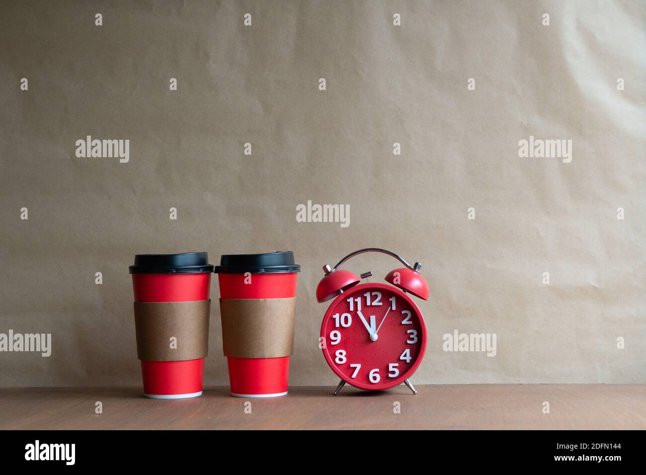 Coffee time concept - two disposable coffee cups and retro alarm clock ...