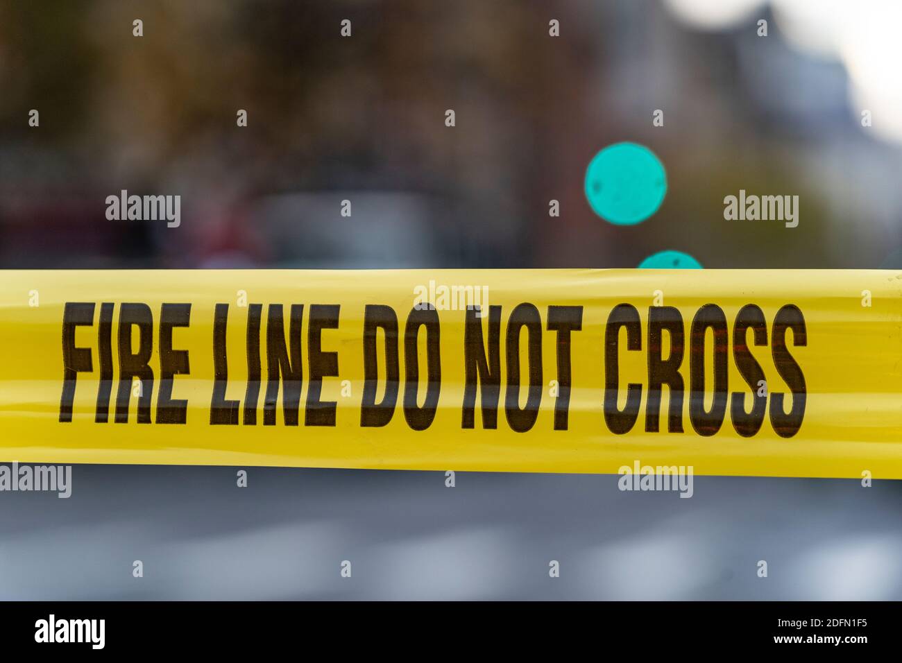 Firefighters install warning tape around fire scene in the city Stock ...