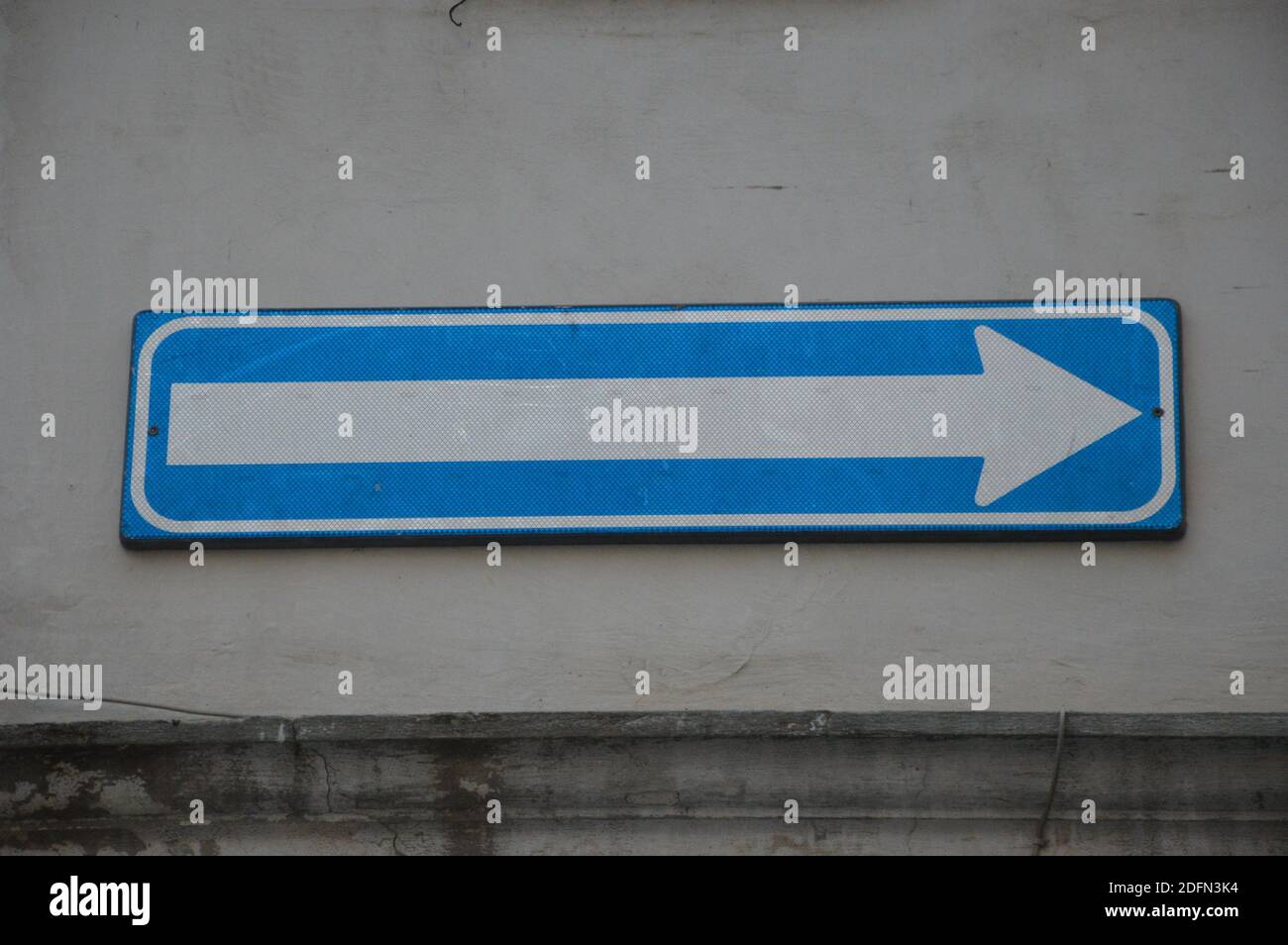 A selective focus closeup of an arrow sign-concept one-way traffic sign ...