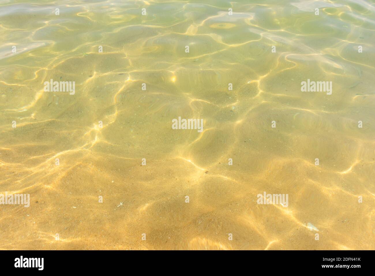 Ripples of water waves reflecting texture on a sandy beach bottom Stock ...