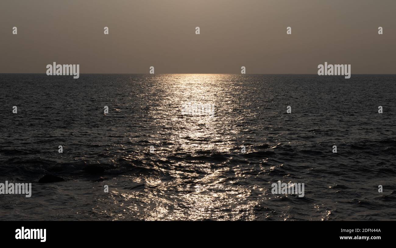 distance ocean sunset reflection on water landscape Stock Photo - Alamy