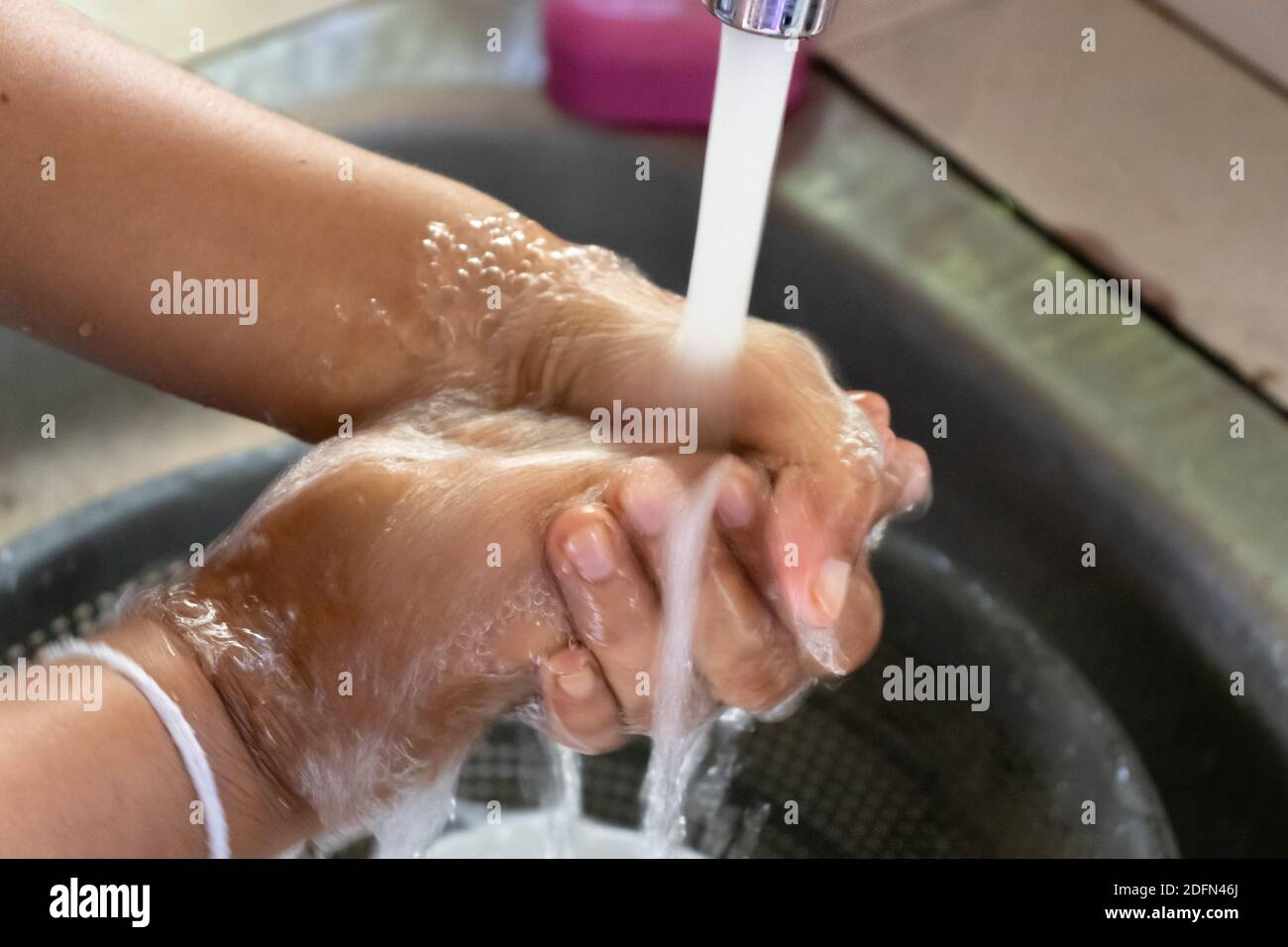applying soap and washing with clean running water Stock Photo - Alamy