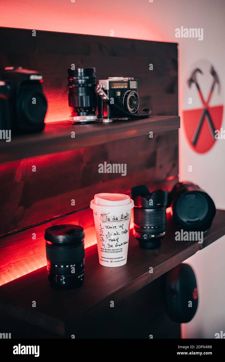A vertical closeup of cameras on the wooden display rack Stock Photo ...