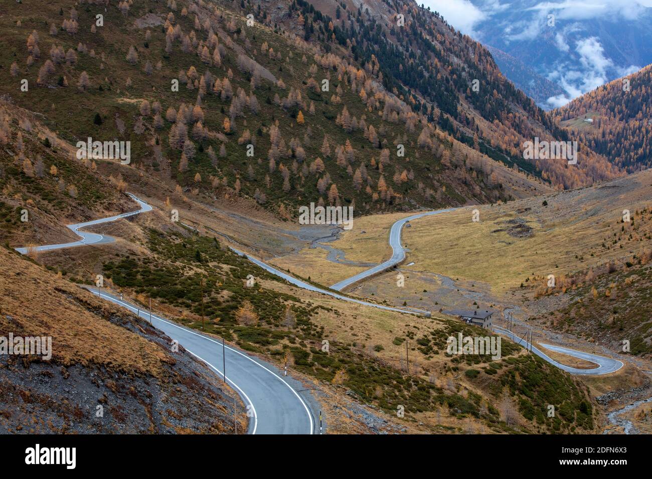 Umbrail Pass, pass road in autumn with wafts of mist, Umbrail, Grisons ...