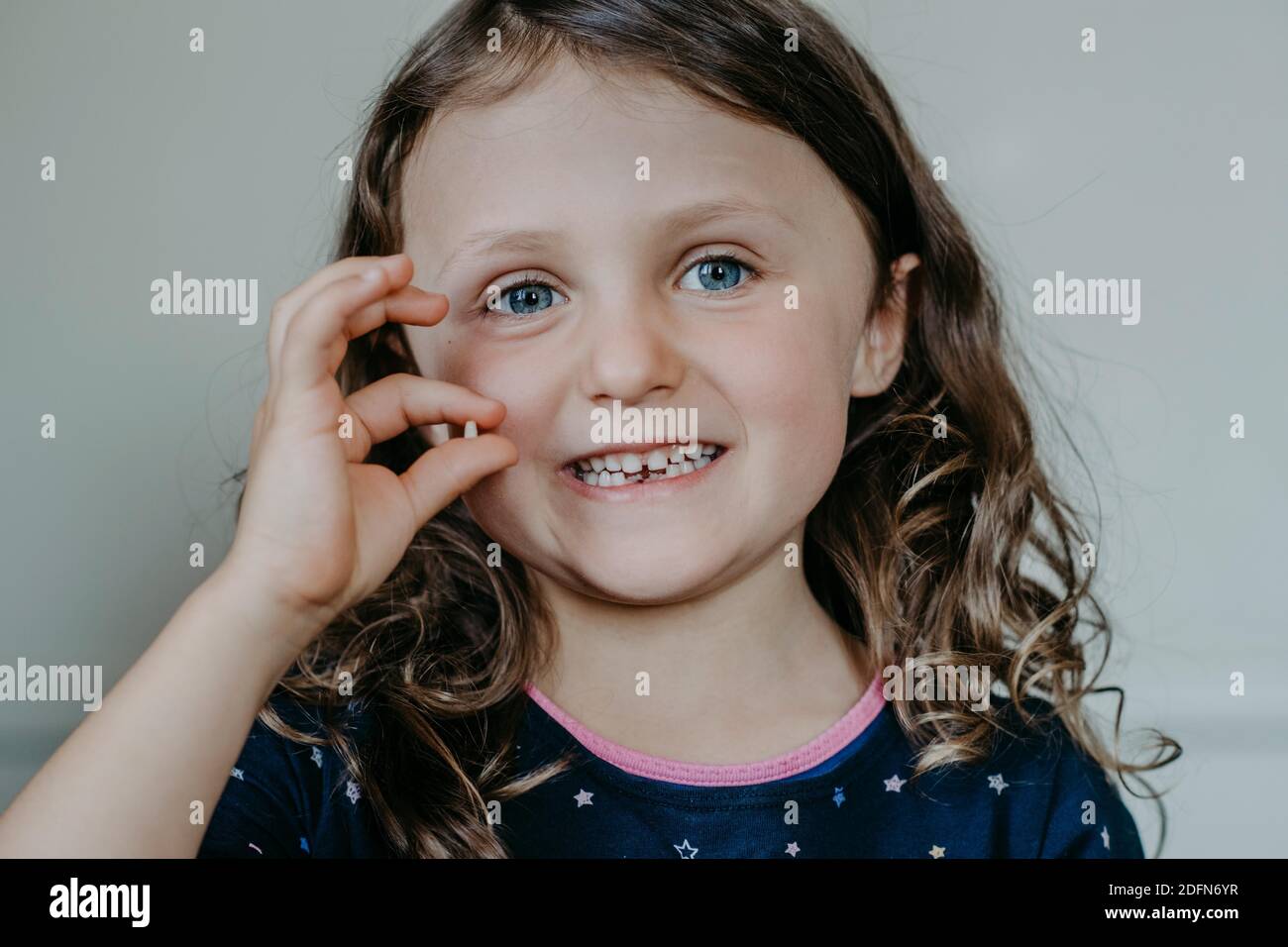 Girl with gap and fallen tooth in her hand Stock Photo - Alamy