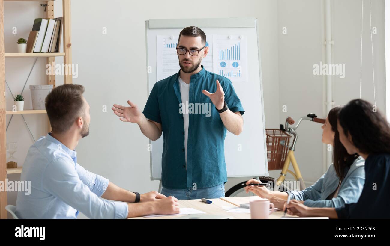 Wide view of businessman lead meeting with employees Stock Photo - Alamy