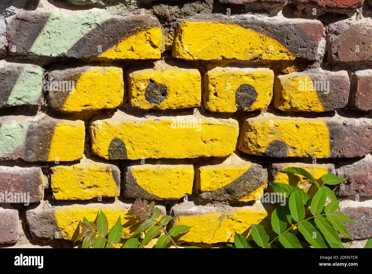 Yellow smiling smiley painted on a brick wall, Germany Stock Photo - Alamy