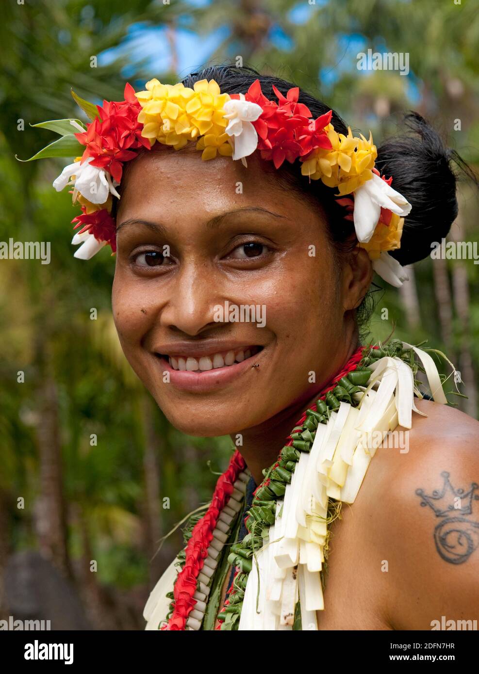 Young smiling local woman with traditional flower decoration, headdress ...