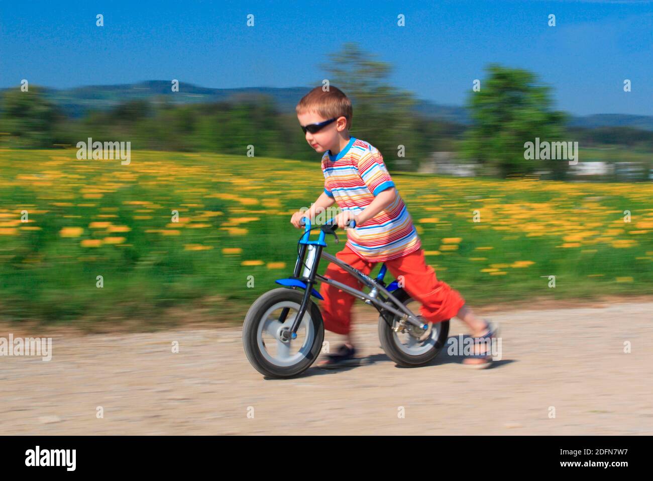 Little boy on wheel Stock Photo - Alamy
