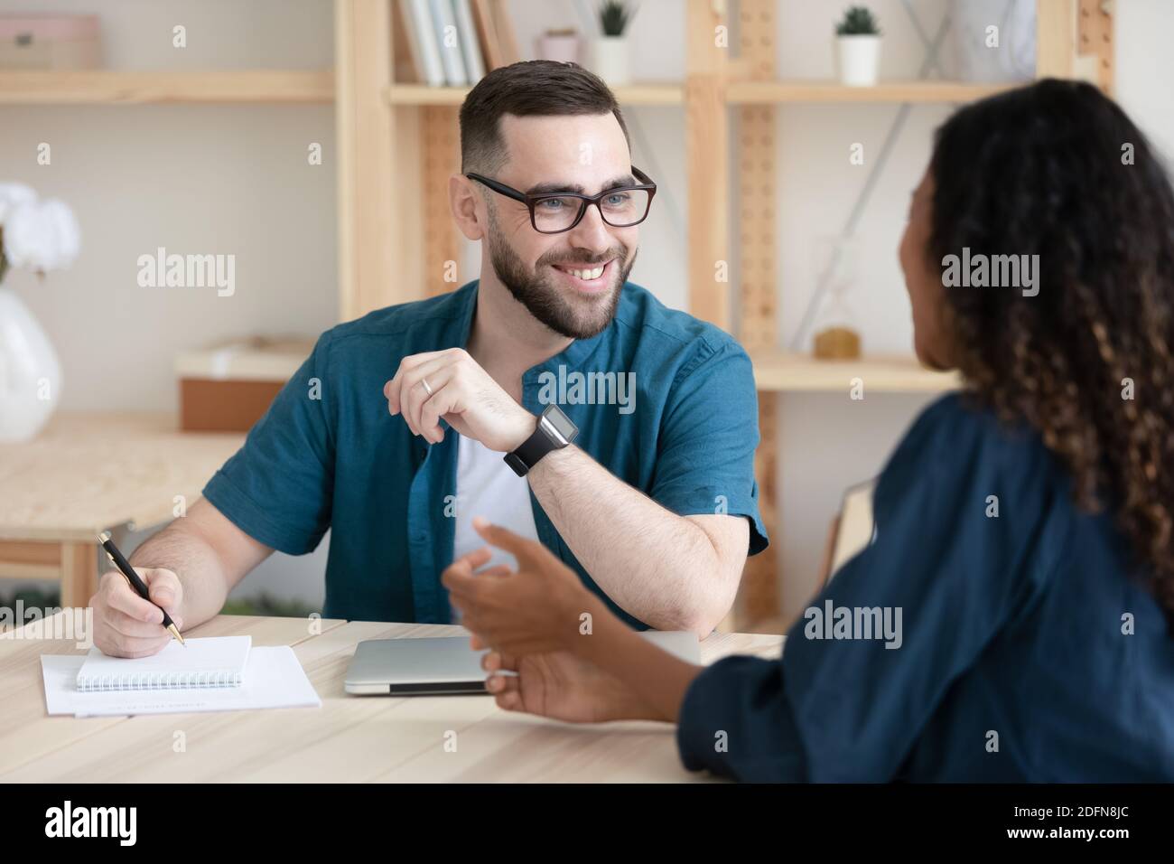 Smiling male employer interview female job candidate Stock Photo - Alamy