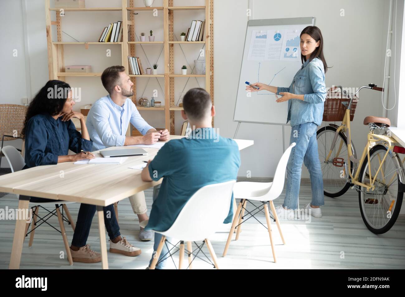 Successful businesswoman present project on flip chart Stock Photo - Alamy