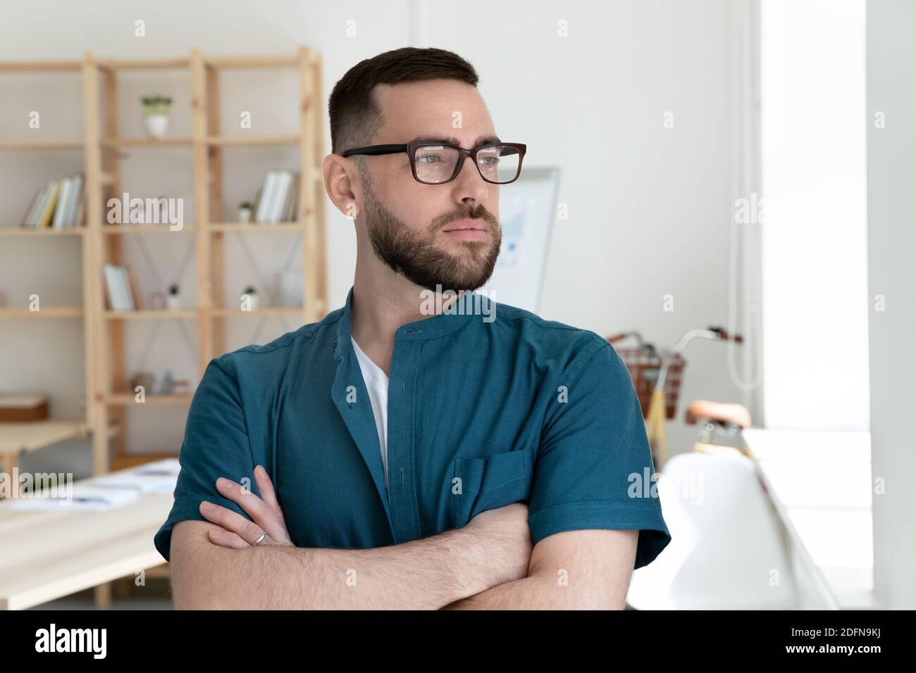 Pensive male employee look in distance thinking Stock Photo - Alamy