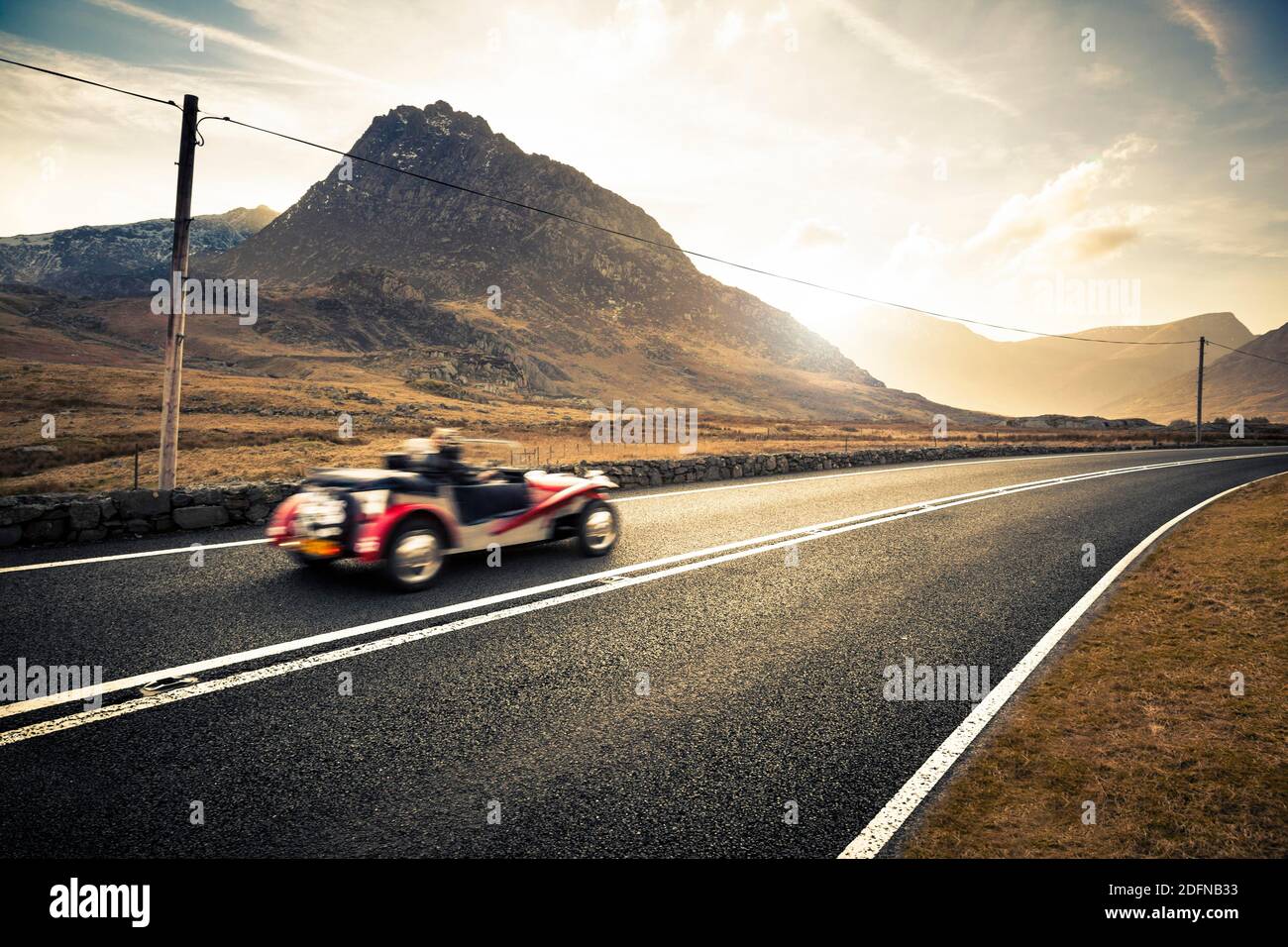 Open top classic sports car driving through Snowdonia, Wales, United ...